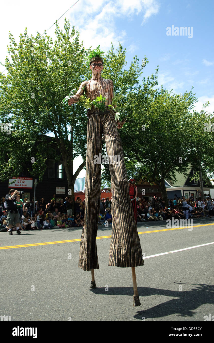 Man on stilts dressed tree hi-res stock photography and images - Alamy