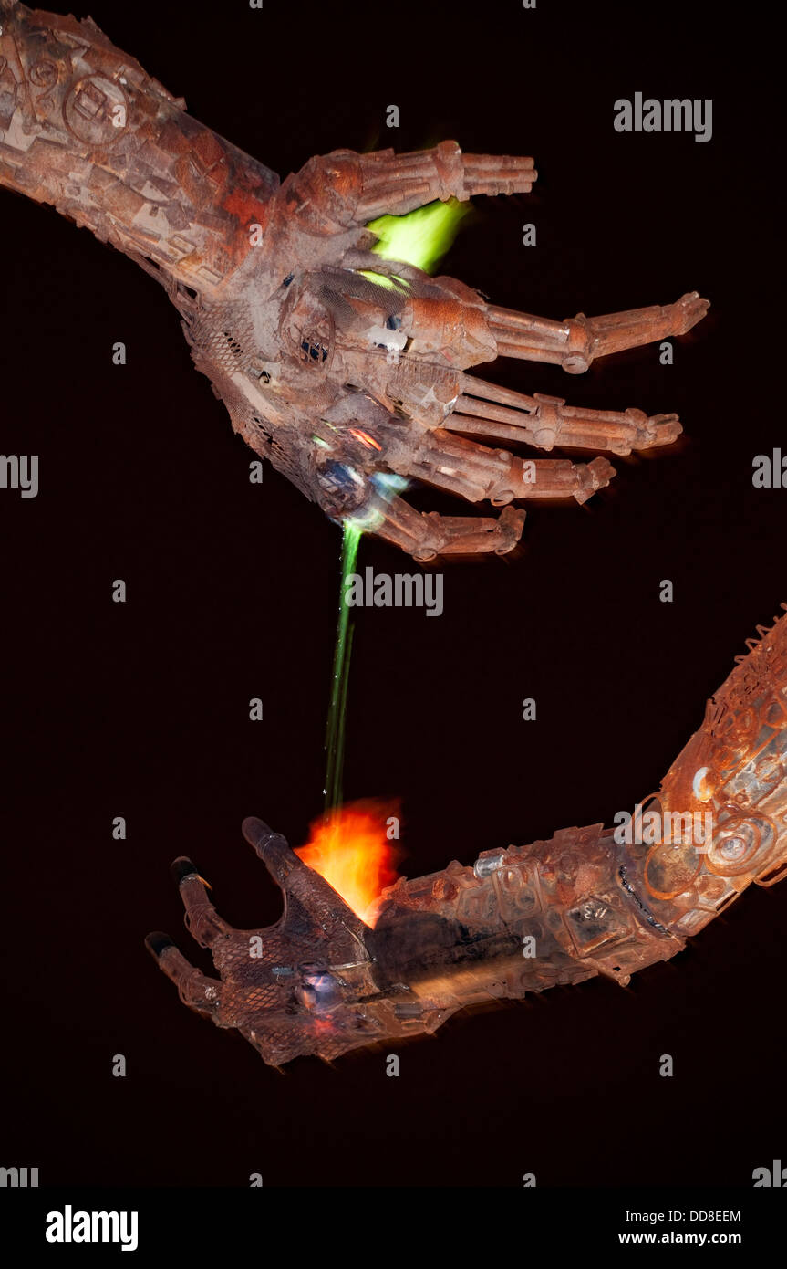 Seattle, WA. Liquid fire pouring from one metal sculpture hand to ...