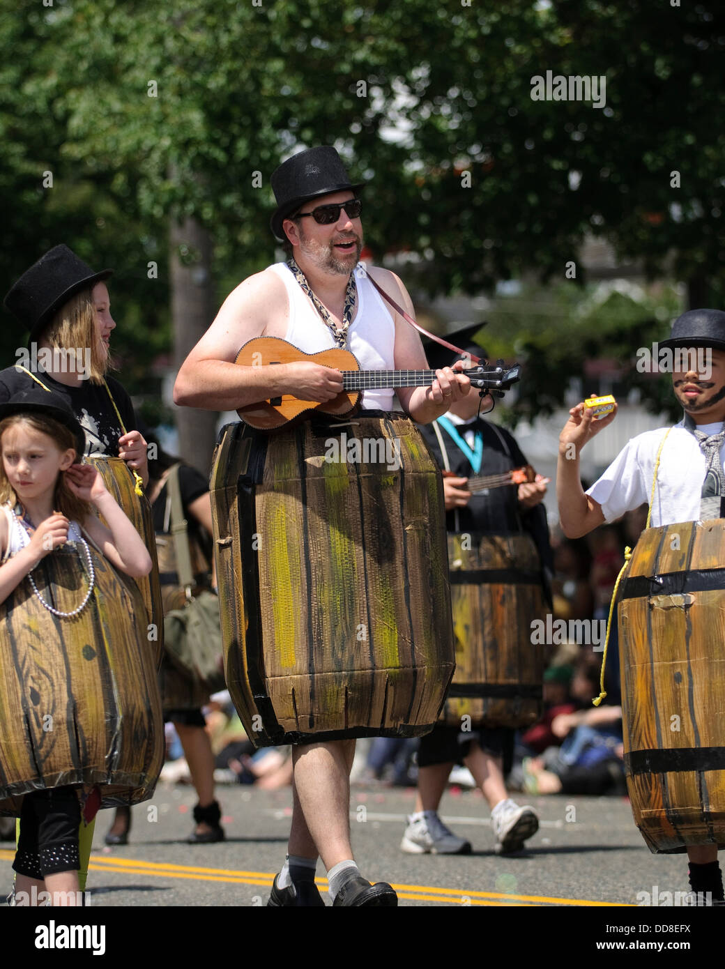 Man and two children wearing barrels in Seattle's Fremont Solstice ...