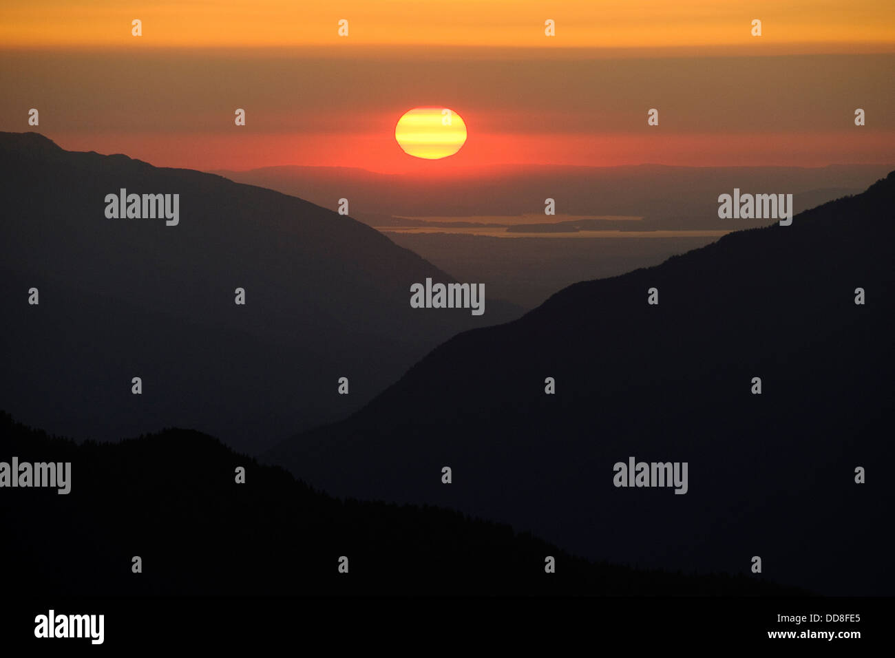 Sun setting between ridgelines, from summit of Hidden Lakes Peak, North ...