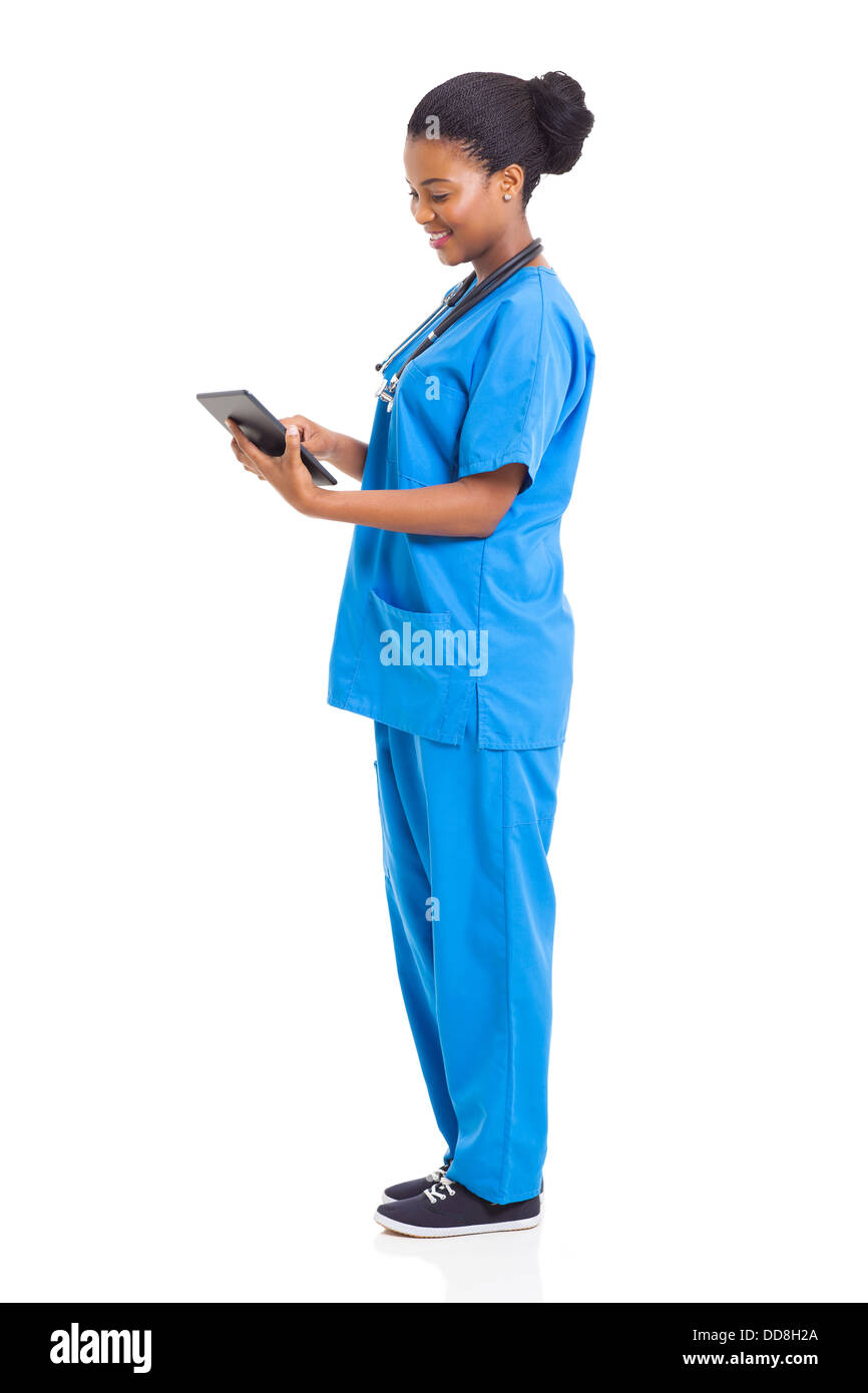 side view of happy African American nurse using tablet computer on ...