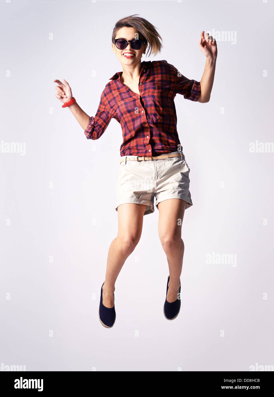 Vertical portrait of a cheerful model enjoying jumping Stock Photo - Alamy