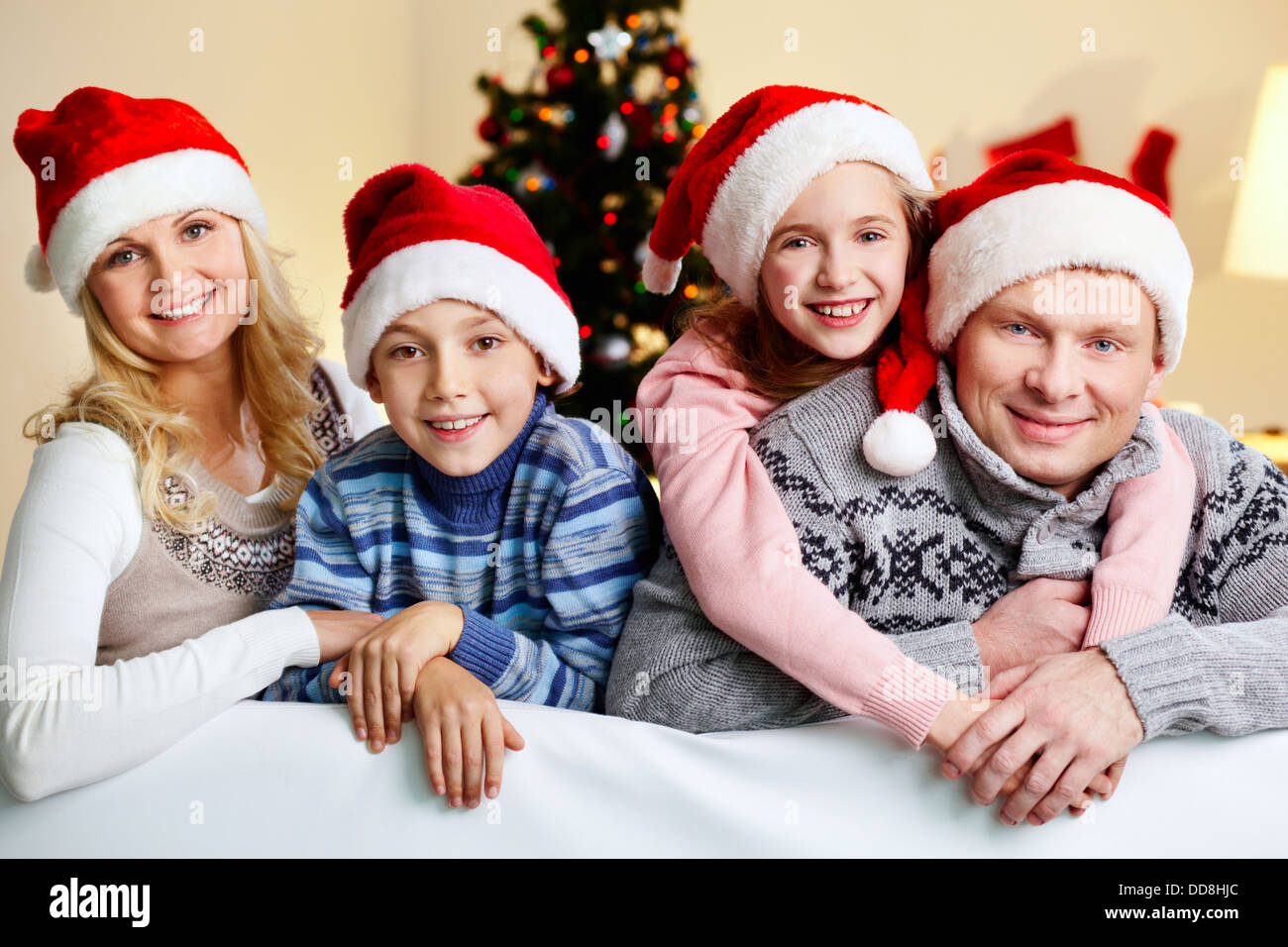 Happy parents and children sharing Christmas hugs Stock Photo - Alamy