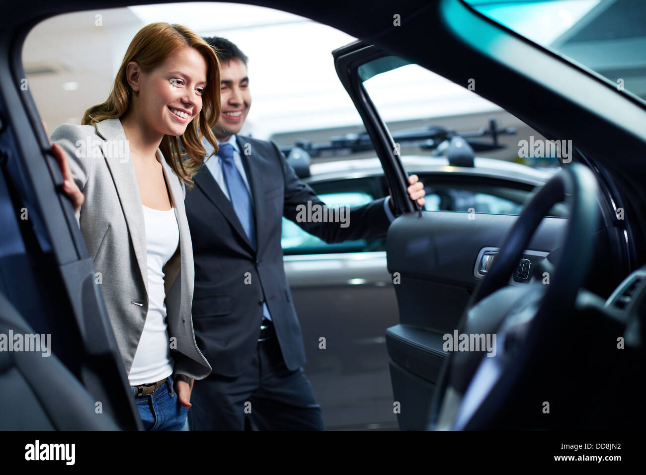 Dealer showing a new car model to the potential customer Stock Photo ...
