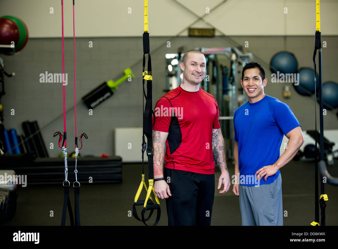 Men smiling together in gym Stock Photo - Alamy