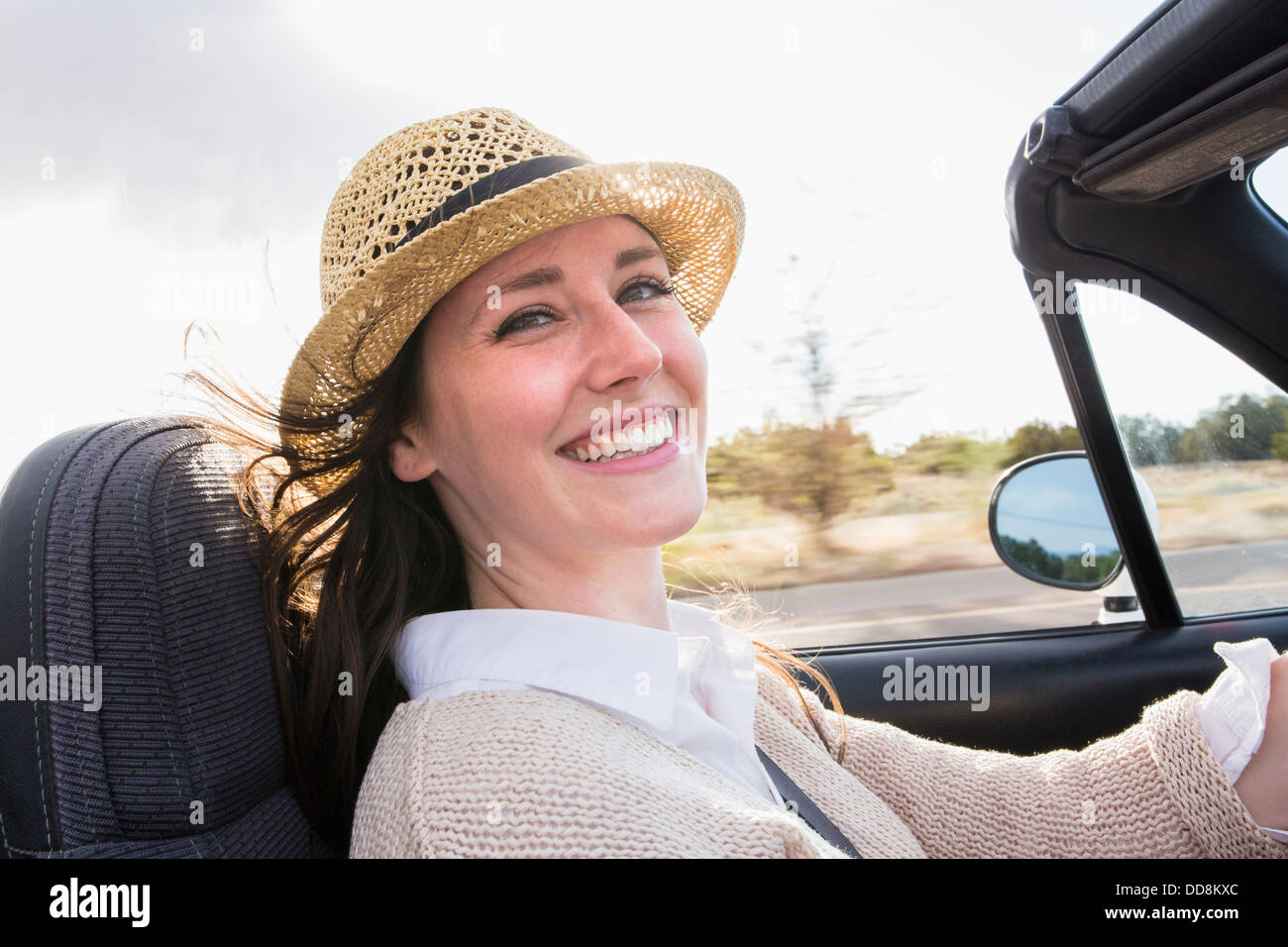 Caucasian woman driving convertible Stock Photo - Alamy