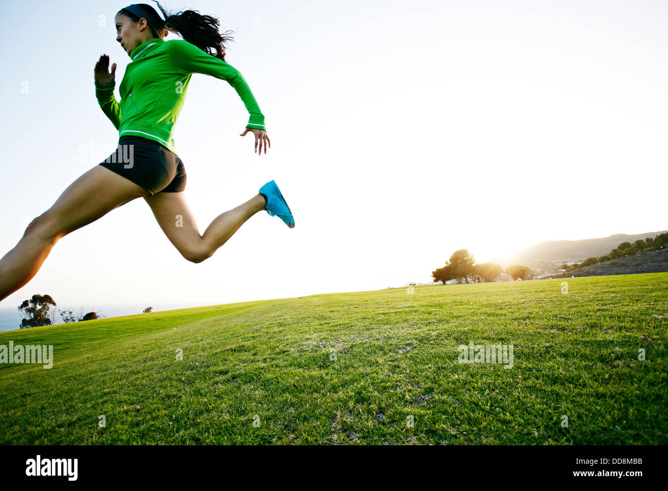 Hispanic woman running in rural landscape Stock Photo - Alamy