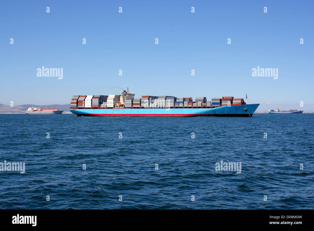 Picture of blue sea with a container ship driving along the horizon ...