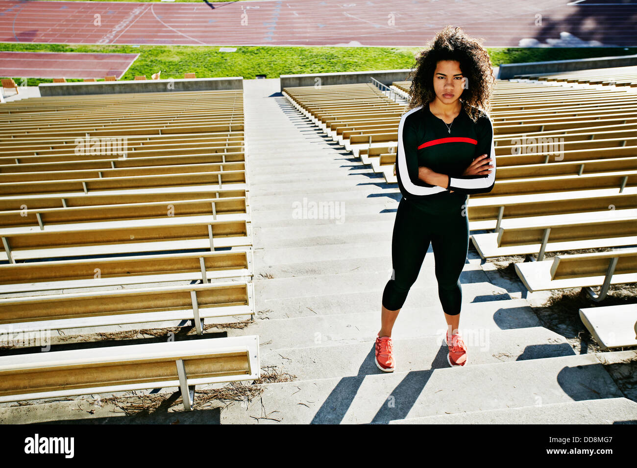 Mixed race runner training in stadium Stock Photo - Alamy