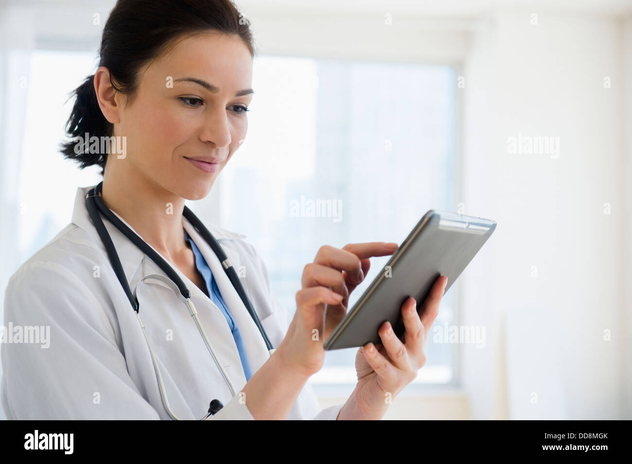 Caucasian doctor using tablet computer Stock Photo - Alamy
