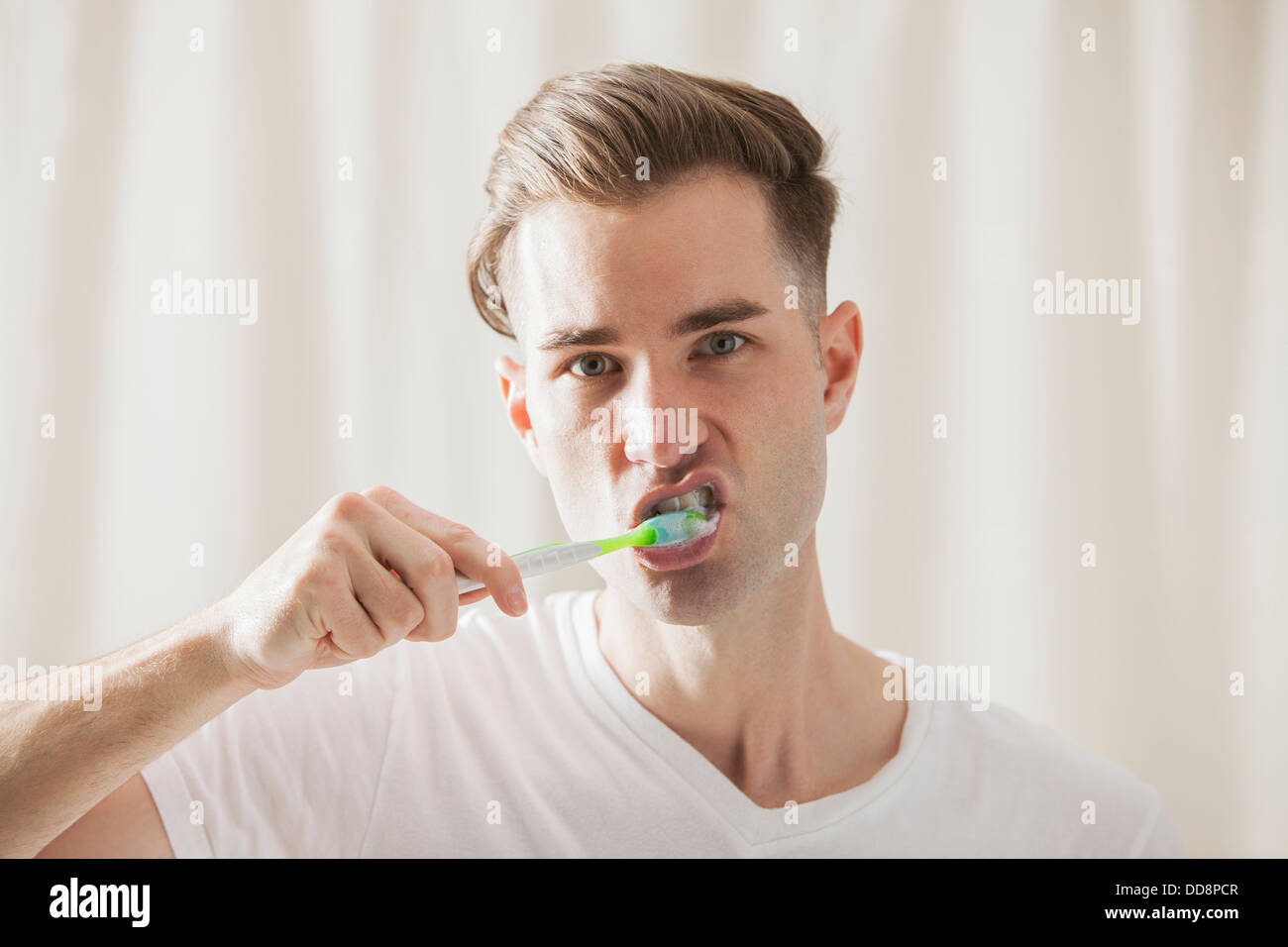 Caucasian man brushing his teeth Stock Photo - Alamy