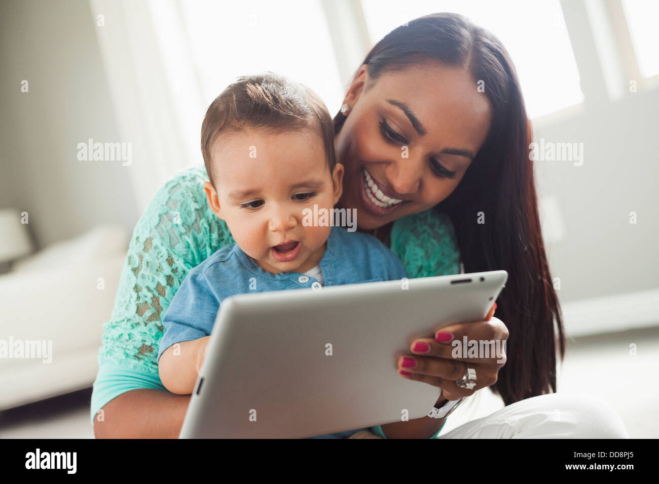 Mother and son using digital tablet Stock Photo - Alamy