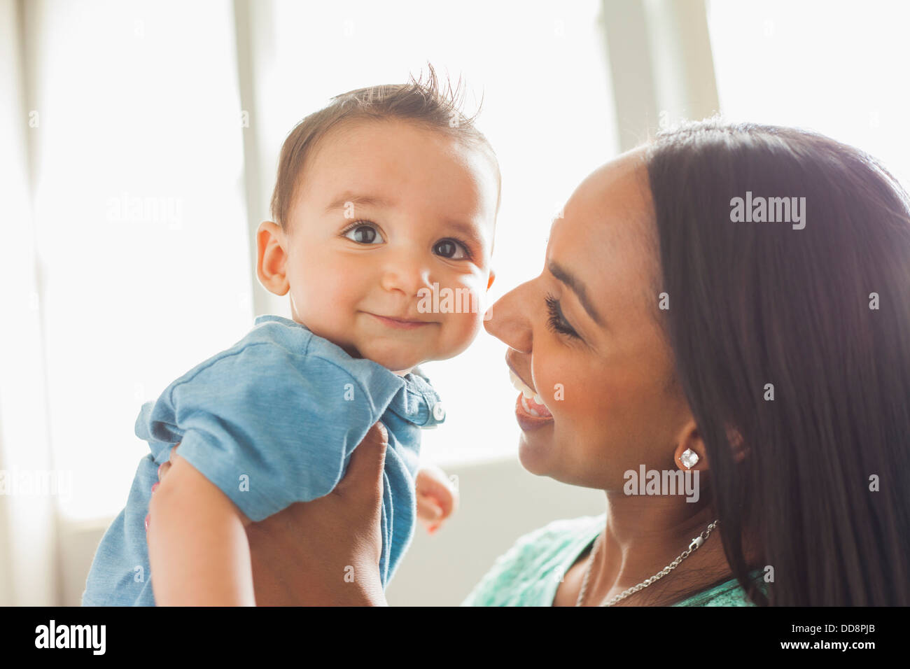 Smiling mother holding son Stock Photo - Alamy