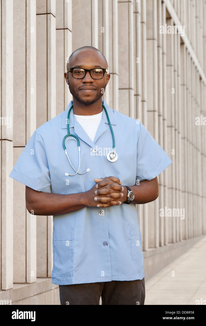 Black doctor standing on city street Stock Photo - Alamy