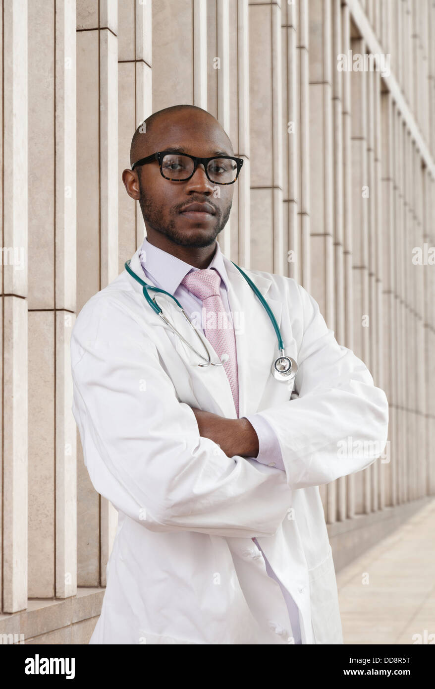 Black doctor standing on city street Stock Photo - Alamy