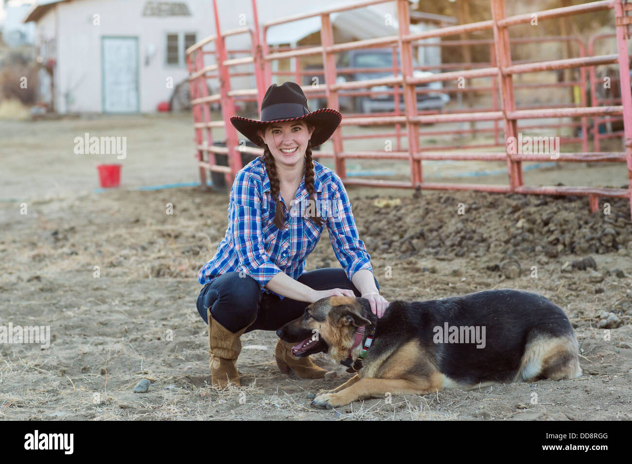 Caucasian girl petting dog on farm Stock Photo - Alamy