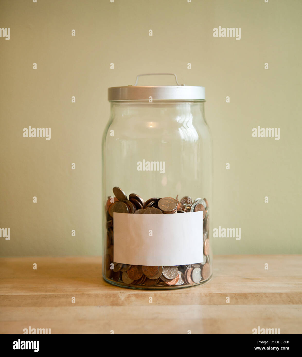 Coins in blank labeled jar Stock Photo - Alamy