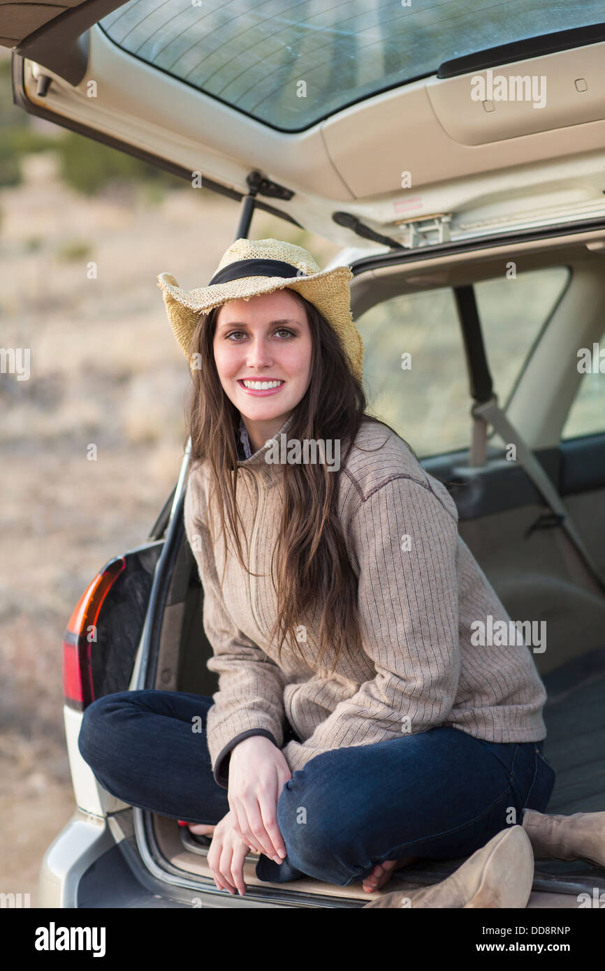 Caucasian woman smiling in hatchback of car Stock Photo - Alamy