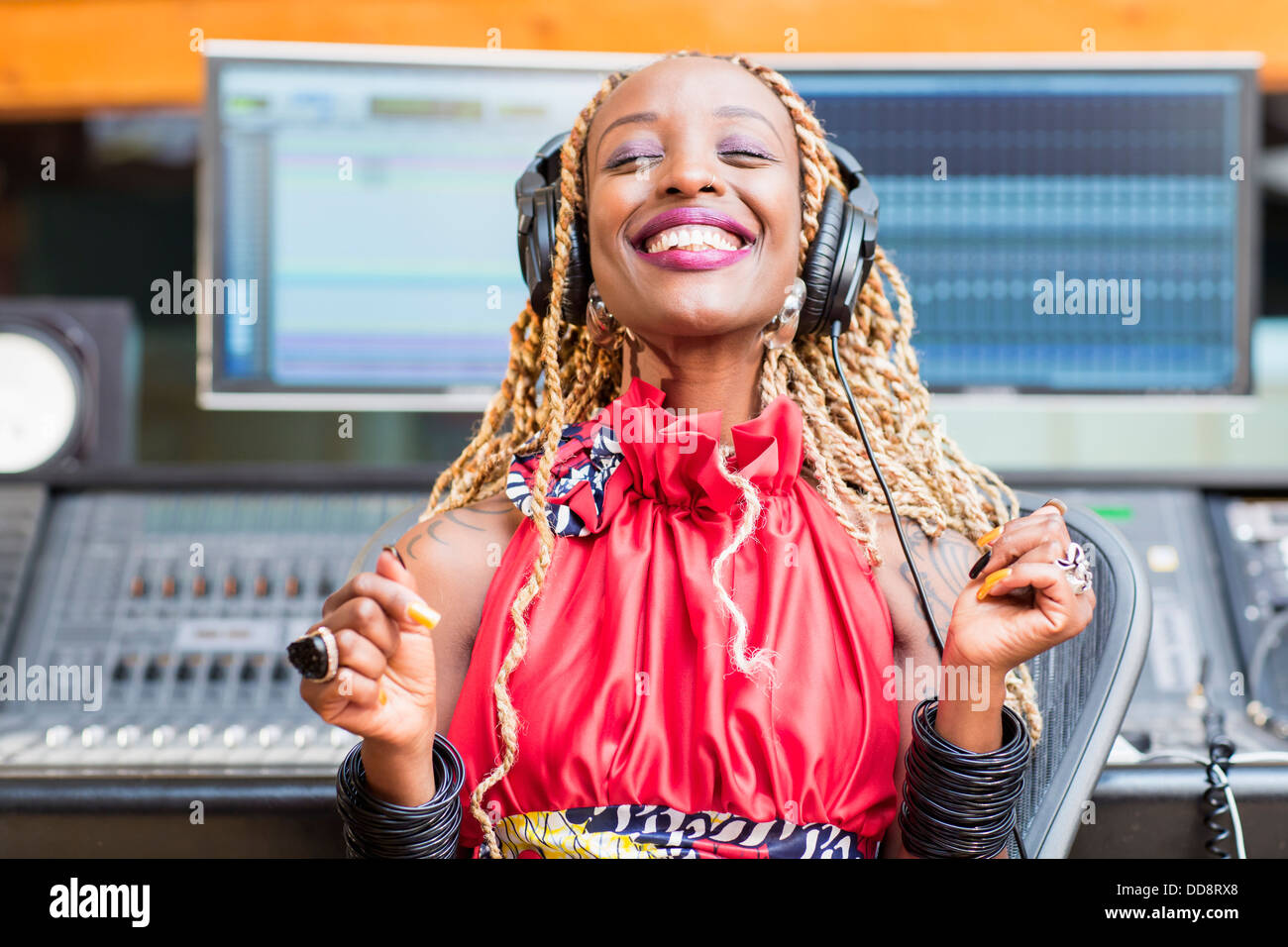 African American singer listening to track in studio Stock Photo - Alamy
