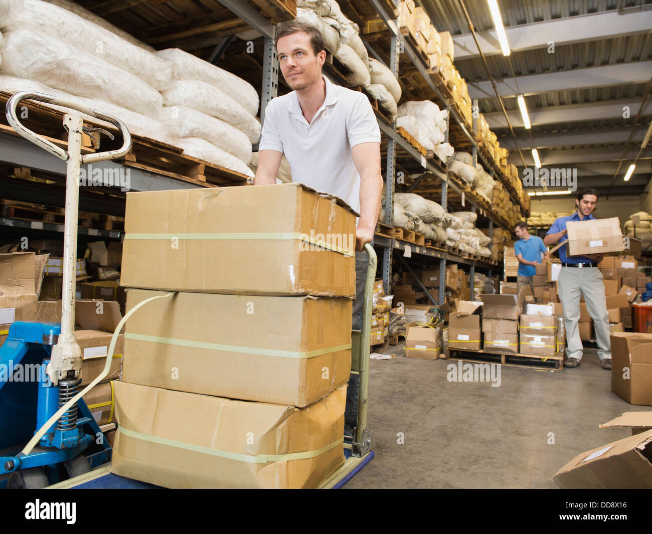 Worker stacking boxes in textile factory Stock Photo - Alamy