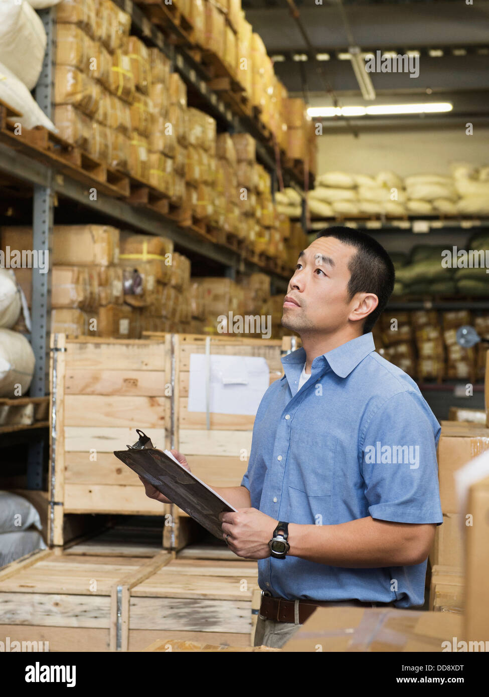 Chinese worker using clipboard in textile factory Stock Photo - Alamy