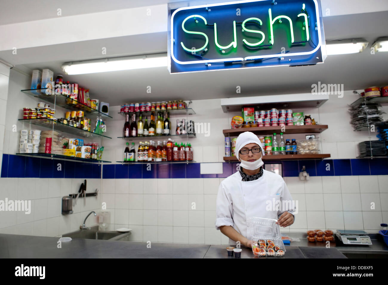 Mixed race chef working in sushi bar Stock Photo - Alamy