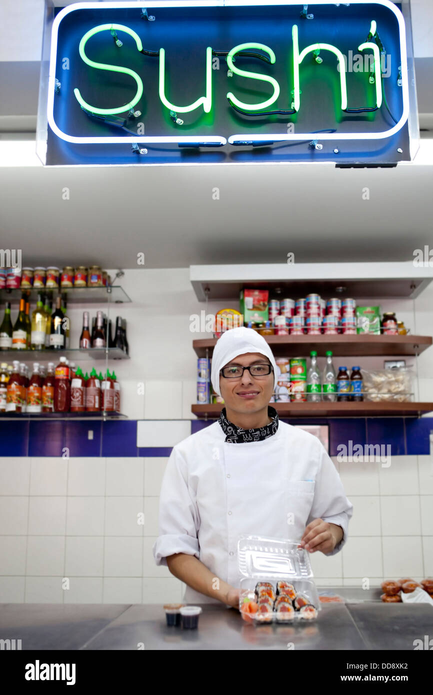Mixed race chef working in sushi bar Stock Photo - Alamy
