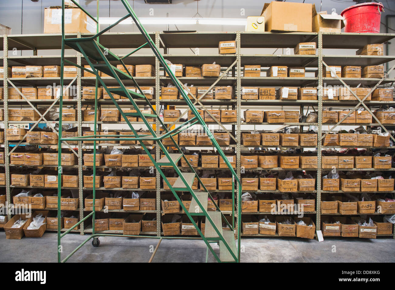Rolling stairs by shelves in textile factory Stock Photo - Alamy