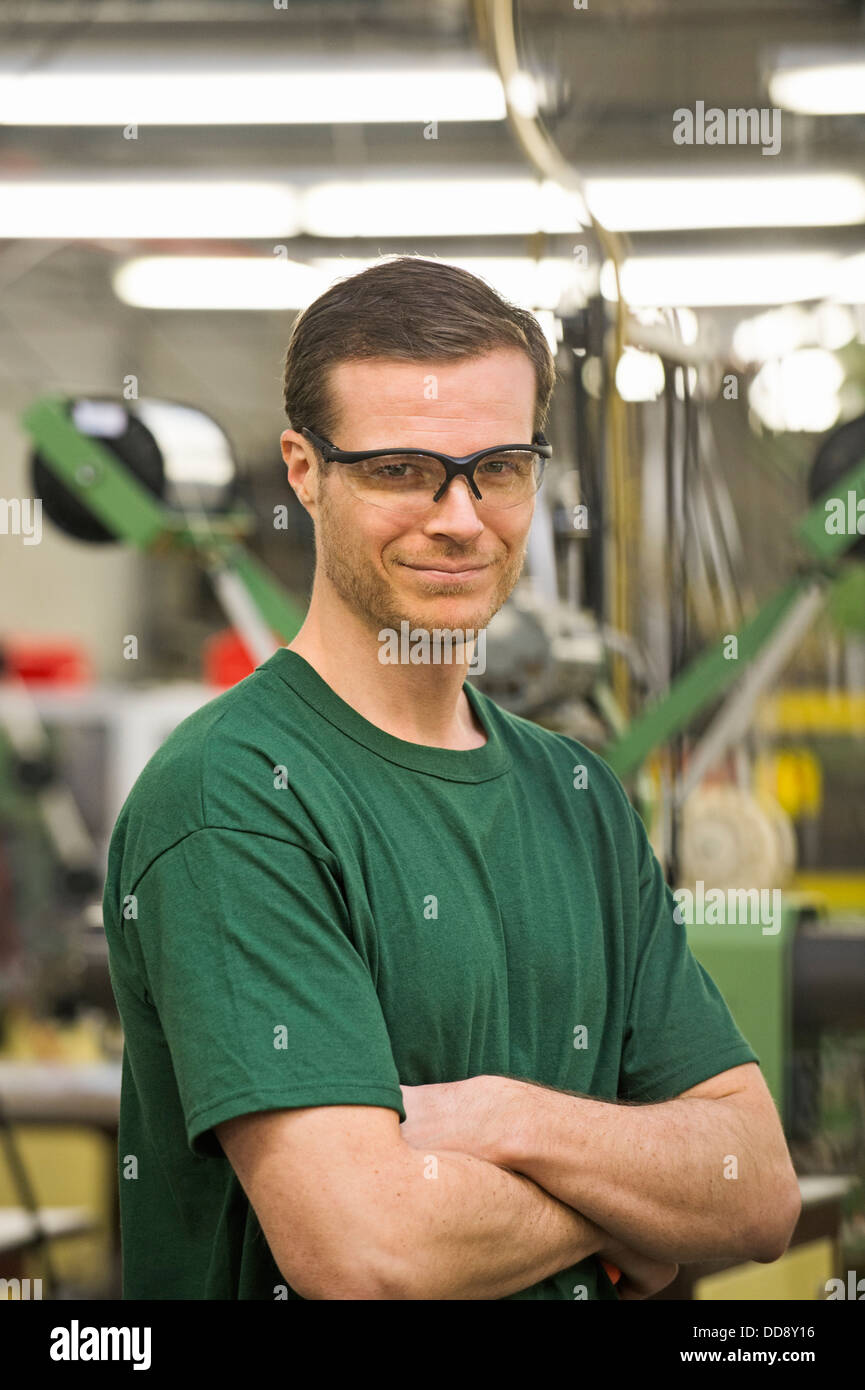 Caucasian worker smiling in textile factory Stock Photo - Alamy
