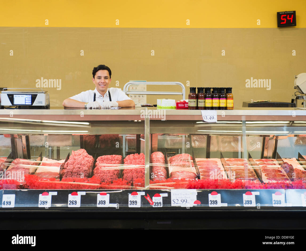 Butcher standing meat counter hi-res stock photography and images - Alamy