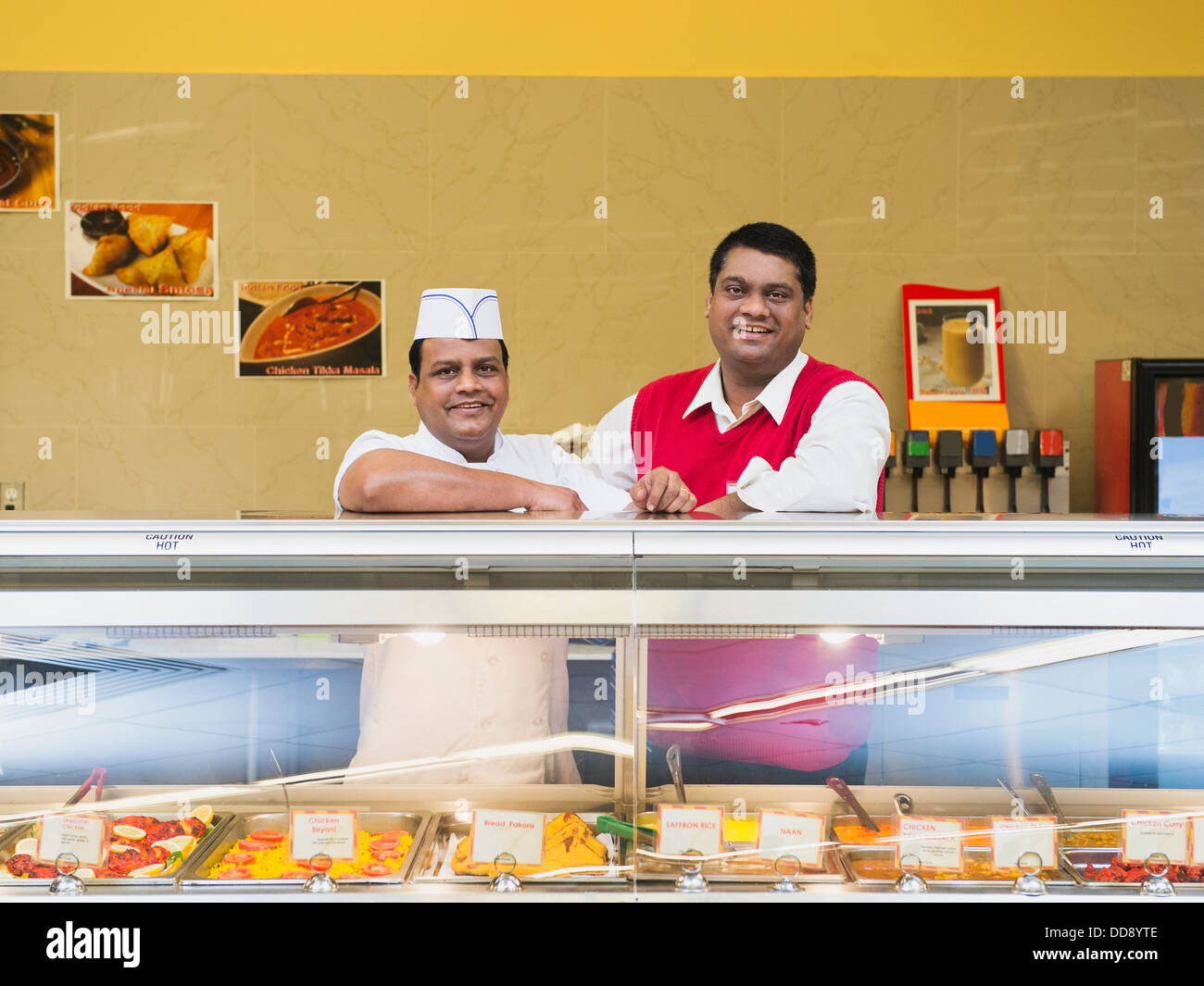 Businessman and chef behind restaurant counter Stock Photo - Alamy