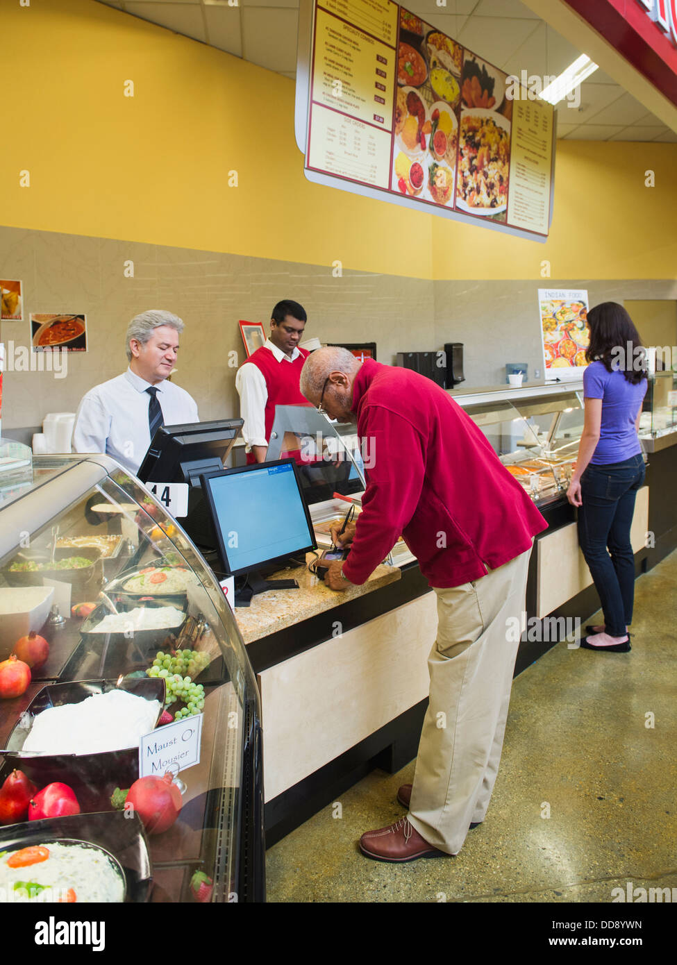 Businessmen and chef serving customers at restaurant counter Stock ...