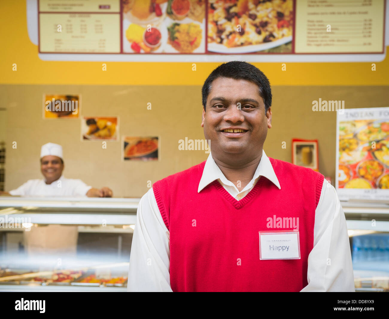 Smiling man standing counter hi-res stock photography and images - Alamy