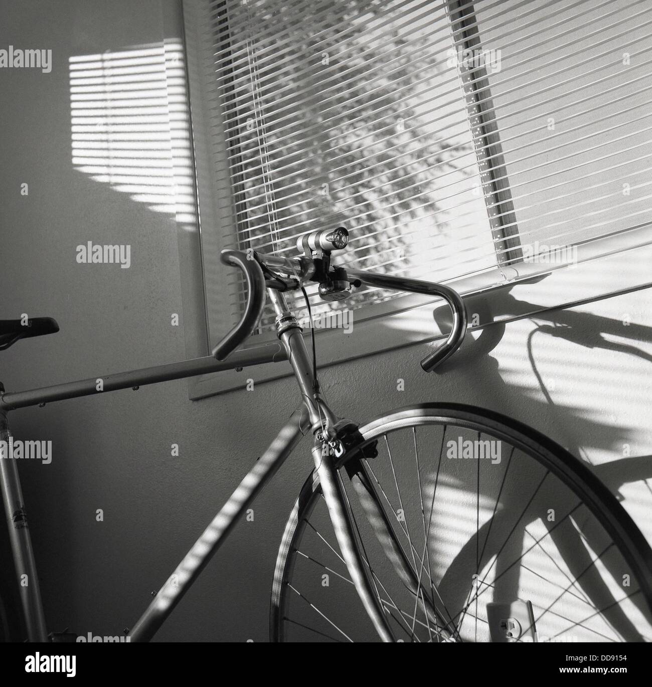 Bicycle under window Stock Photo - Alamy