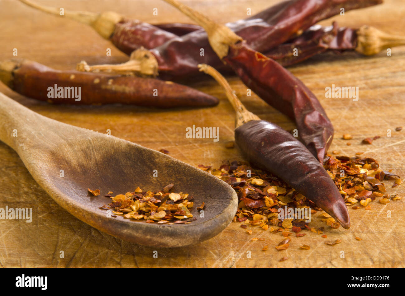 chilli flakes on a wooden spoon Stock Photo - Alamy
