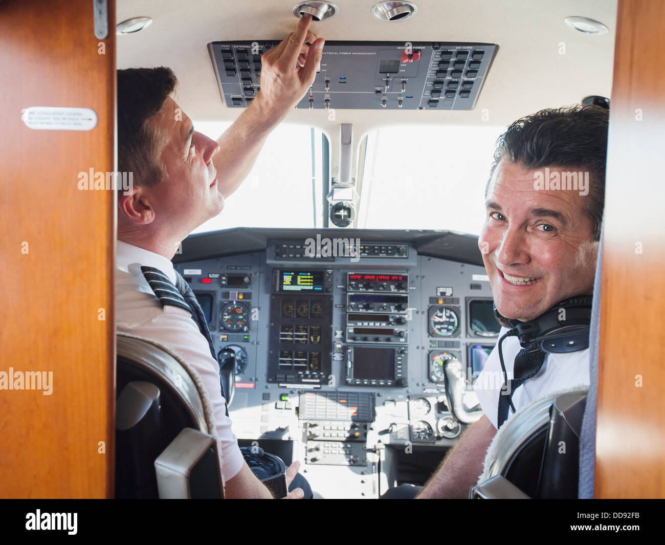 Caucasian pilots in airplane cockpit Stock Photo - Alamy