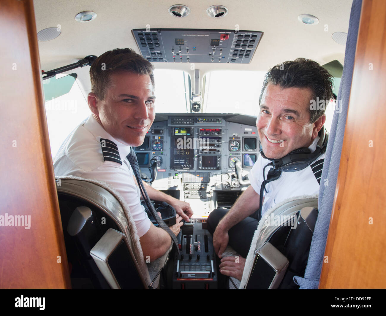 Caucasian pilots in airplane cockpit Stock Photo - Alamy