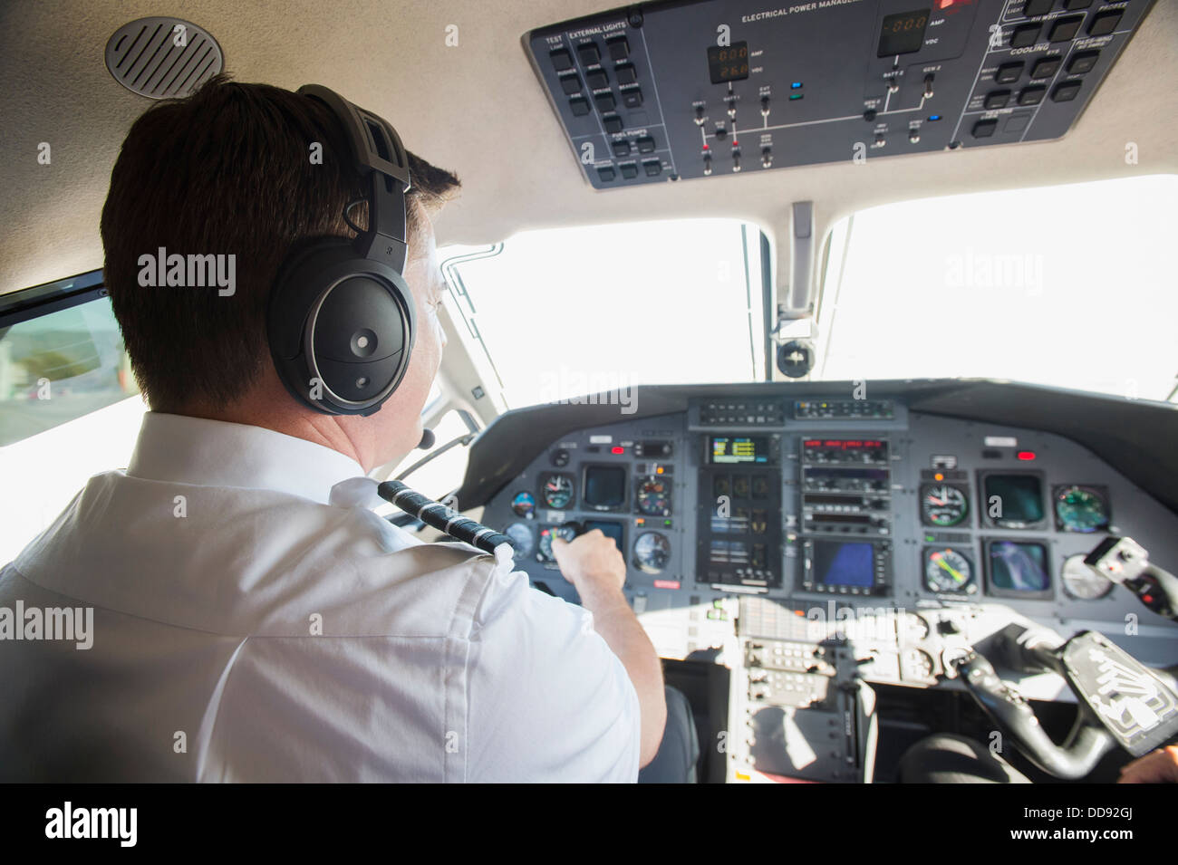 Caucasian pilot working in airplane cockpit Stock Photo - Alamy