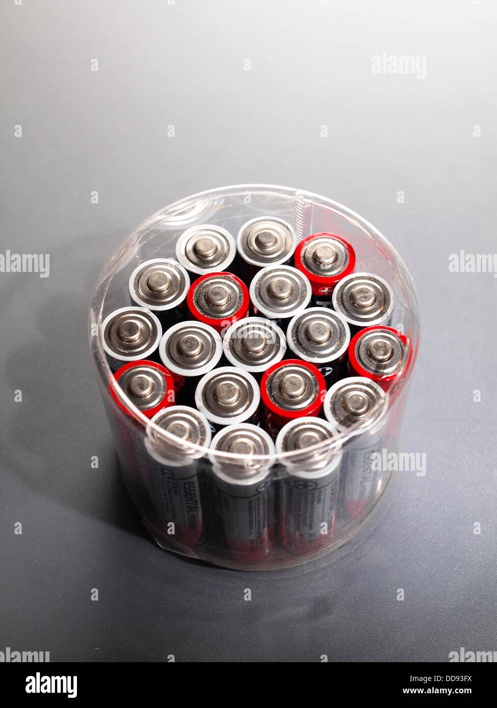 Batteries for recycling in a round plastic box on a gray background ...