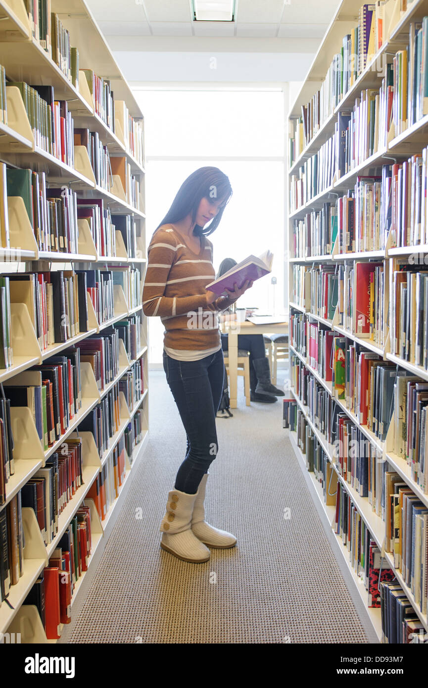 Student reading in library Stock Photo - Alamy