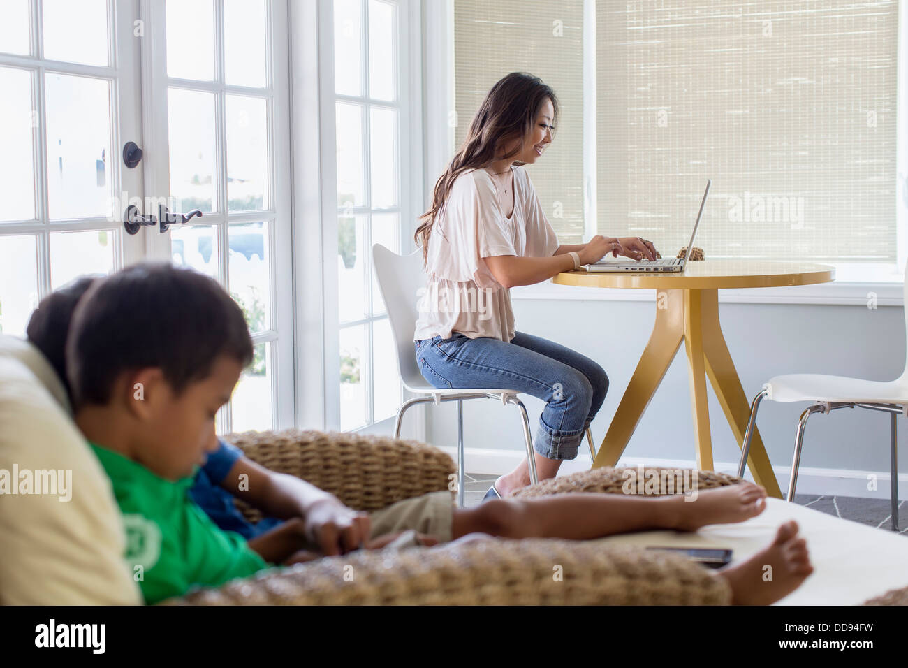 Family relaxing in living room Stock Photo - Alamy
