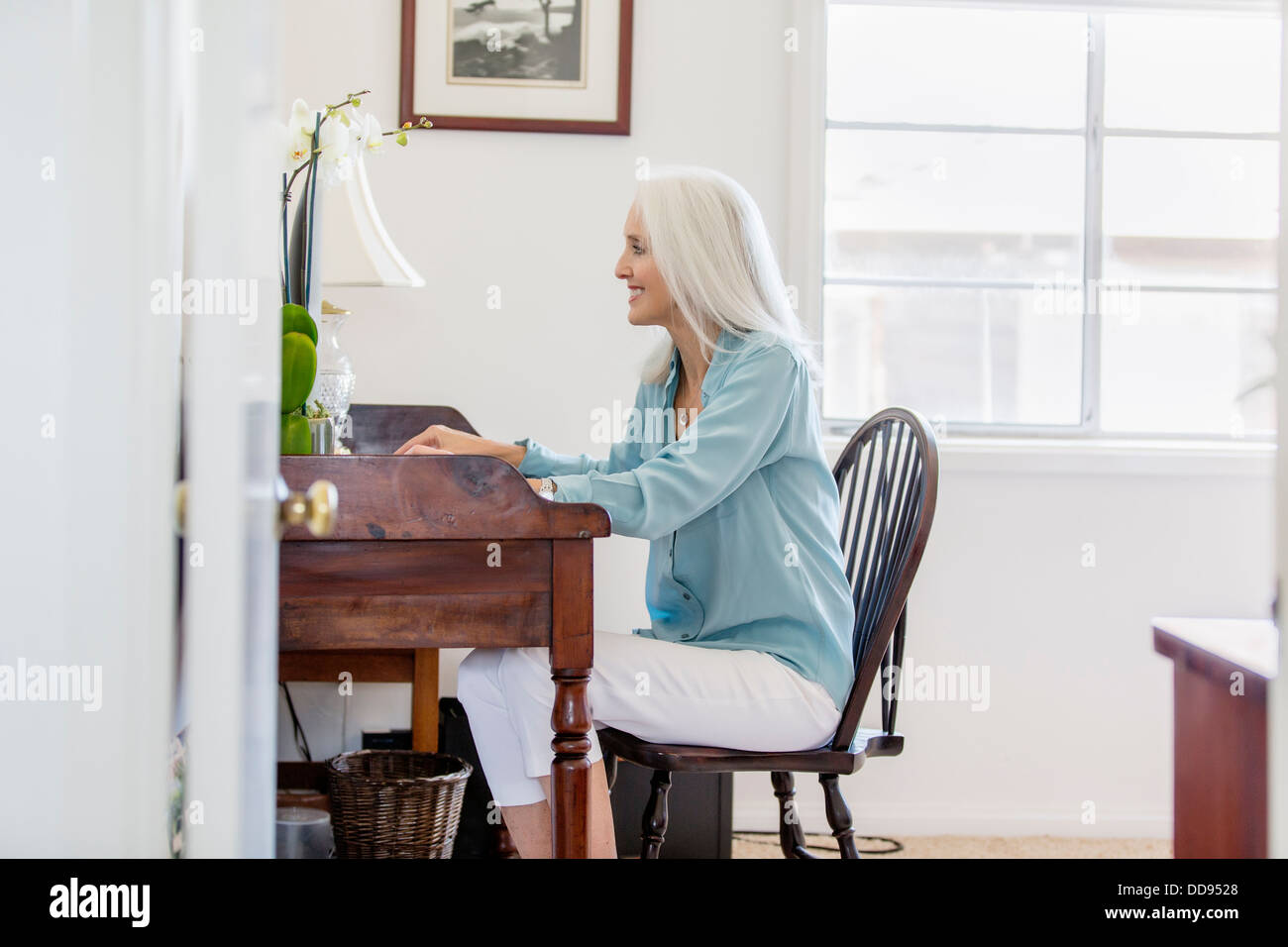 Older Caucasian woman at desk Stock Photo - Alamy