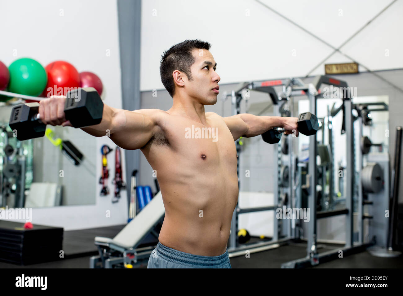 Pacific Islander man lifting weights in gym Stock Photo - Alamy
