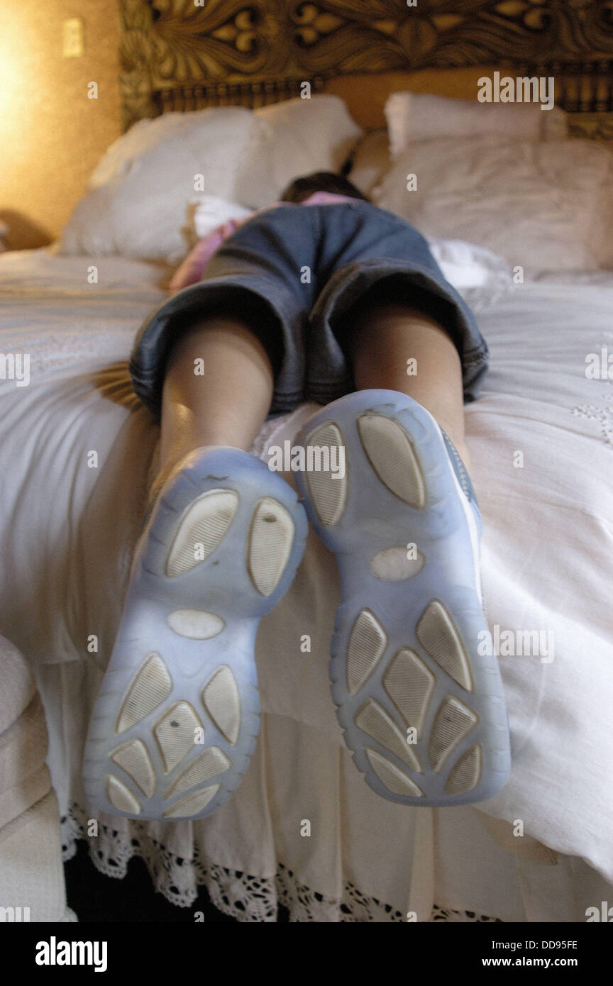 Teenager resting on bed Stock Photo - Alamy