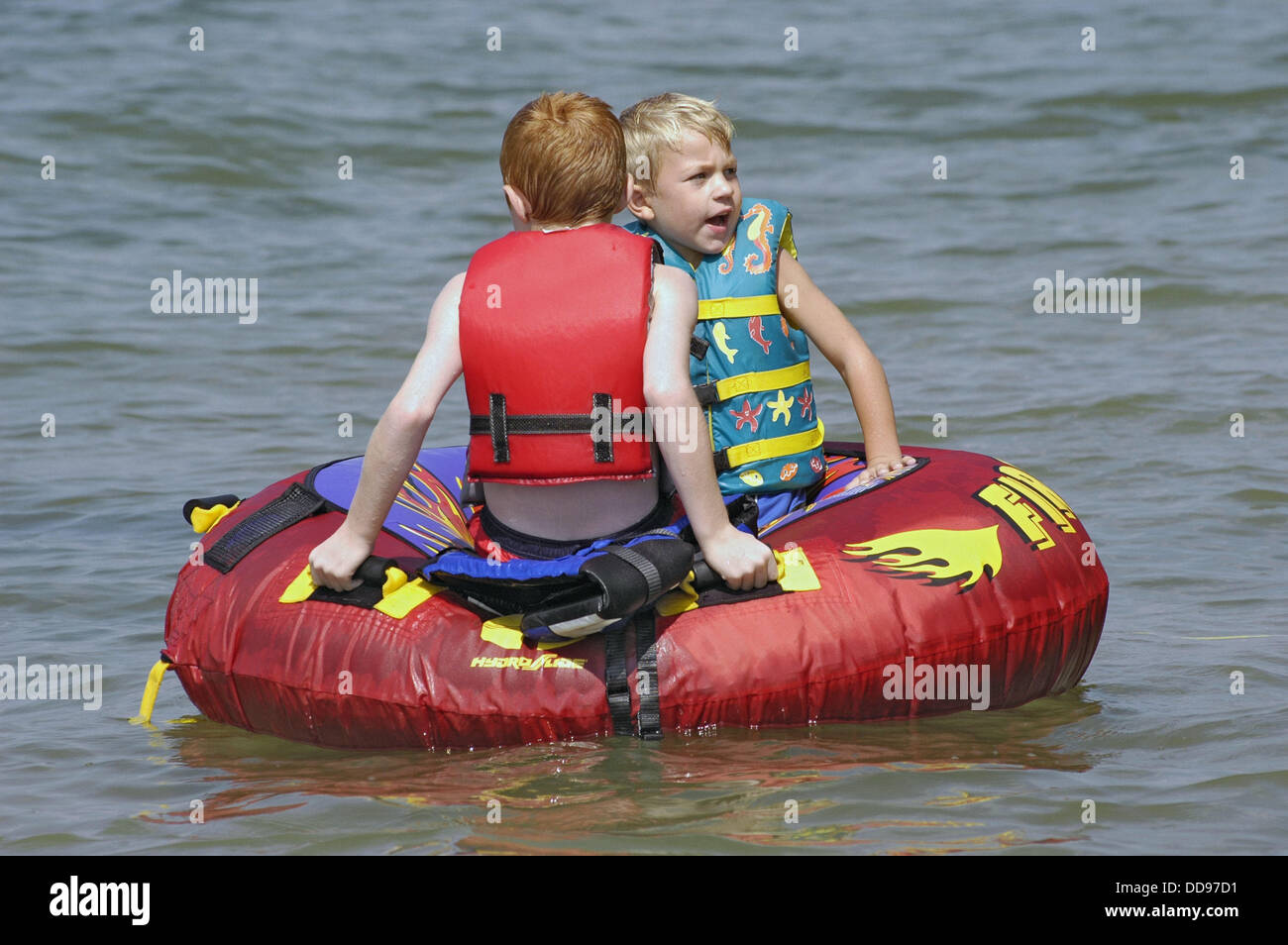 Kids with their inflatable boat at lake Stock Photo - Alamy
