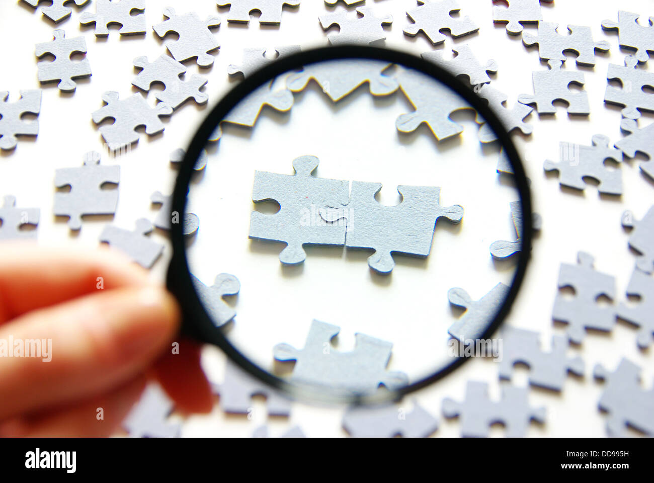 magnifying glass and puzzle Stock Photo - Alamy