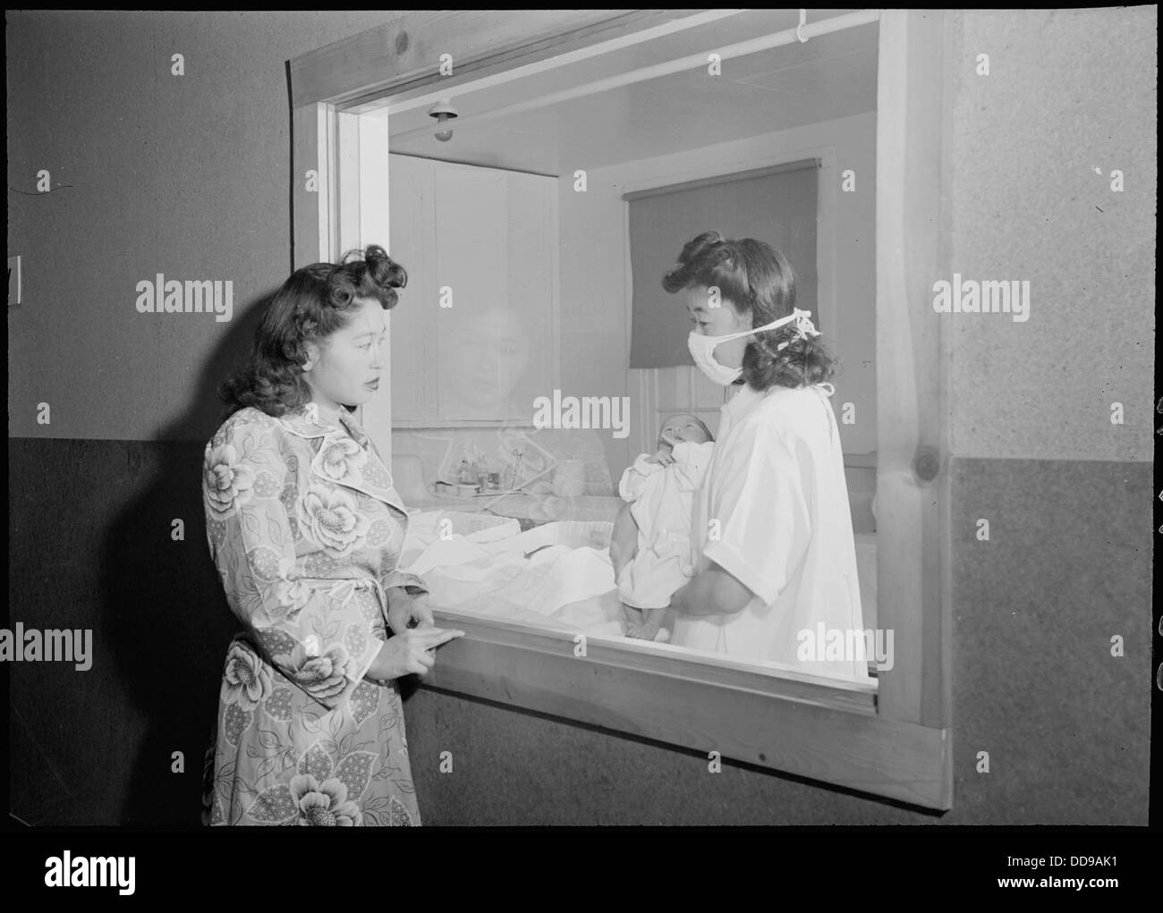Mrs. Mari Yoshida gazes at her baby through the bars of her internment ...