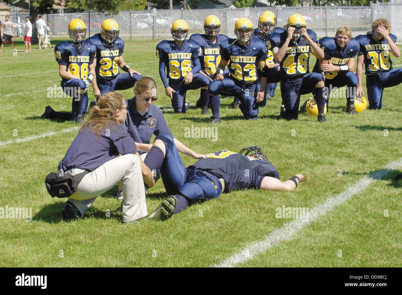 Medical staff tends to injury during football game Stock Photo - Alamy