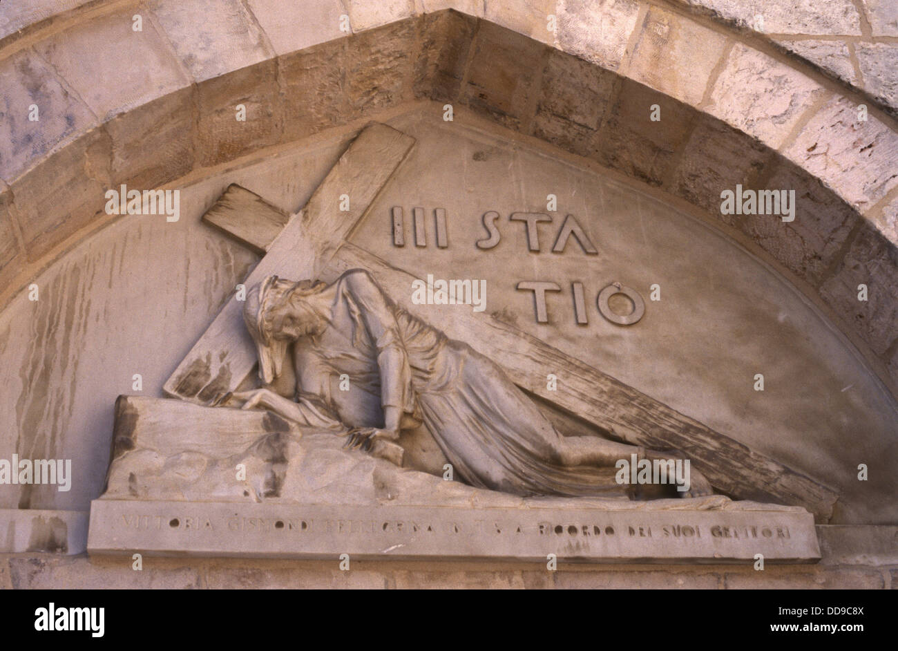 Carved figure of Jesus falling with the cross for the first time at the ...