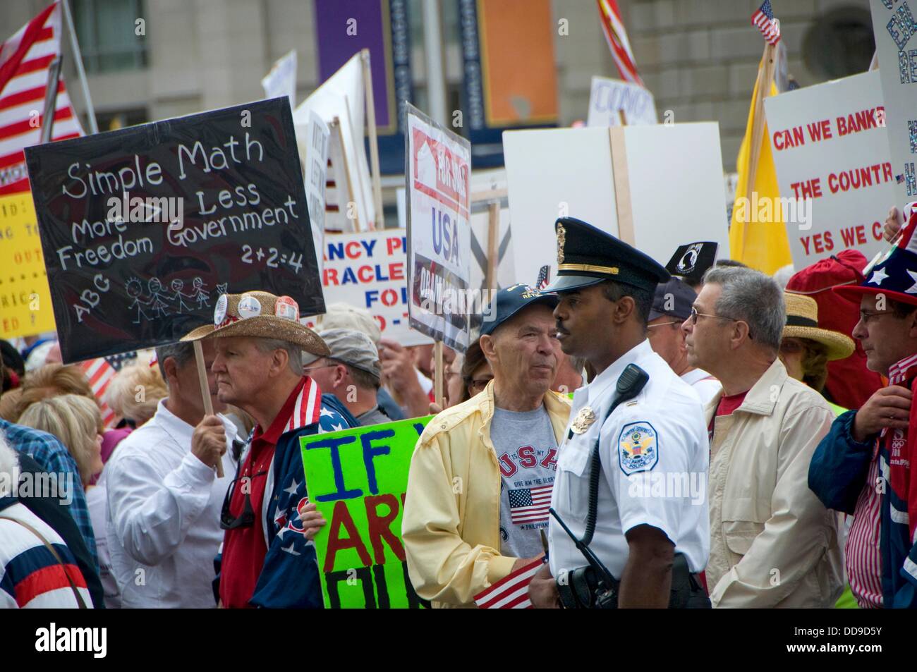 African American Male Police Officer controls crowd at protest rally ...